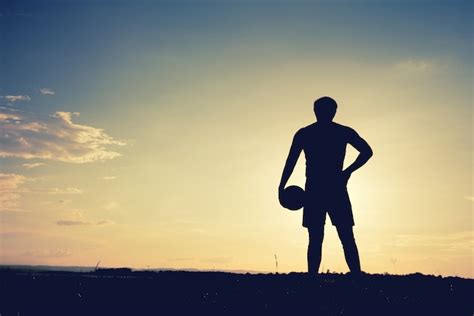 Premium Photo Soccer Player Man Standing Rear View In Silhouette Isolated On Sunset Background