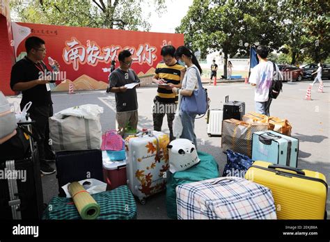 Students Walk With Their Luggage In Hand In The Campus Of Nanjing