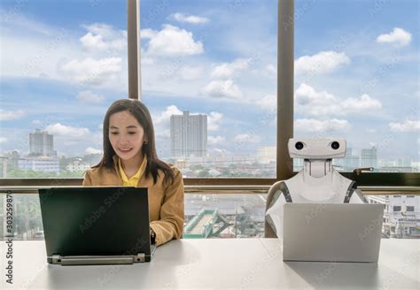 Working Women And Robot Computers In The Office Business RPA Robotic Process Automation Stock