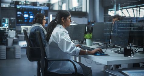 연구실에서 컴퓨터로 작업하는 다양한 젊은 인도 동료들 협업 산업 기술 프로젝트를 위한 솔루션을 연구하는 여성 소프트웨어 개발자 동료에 집중 Stem 주제에 대한 스톡 사진