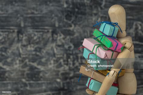 Wooden Puppet Walking Stack Heap Of T Boxes On Black Textured Background With Copy Space Wooden Puppet Walking Stack Heap Of T Boxes On Black Textured Background With Copy Space