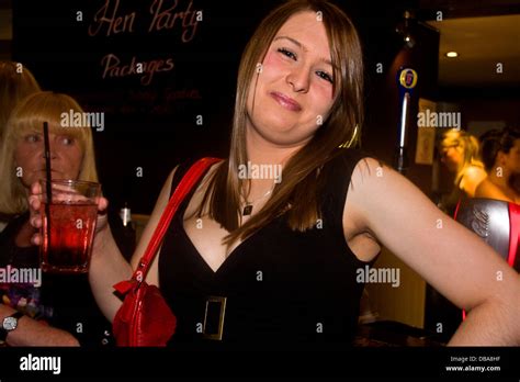 An Attractive Busty Woman Holding A Drink Having Her Photograph Taken