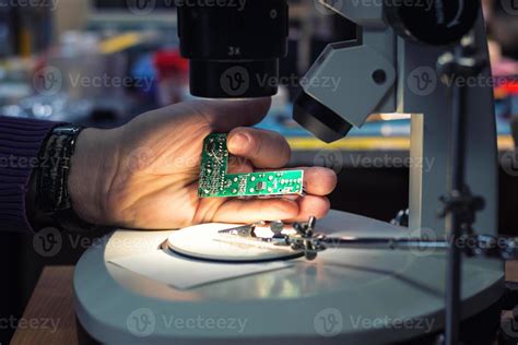 Close Up Of IT Technician Examining Computer Part Under Microscope Stock Photo At Vecteezy