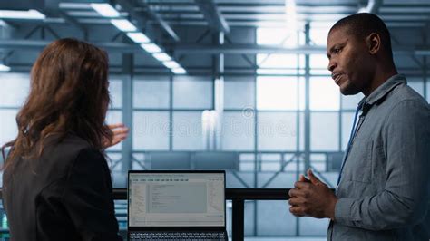 Server Room Coworkers Using Artificial Intelligence On Laptop And