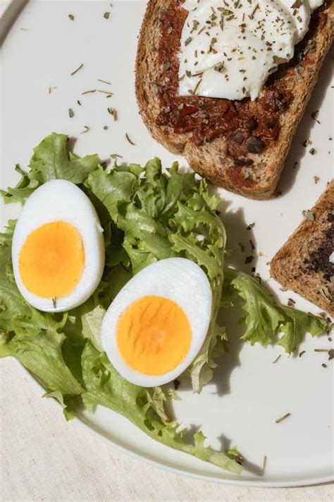 가벼운 식사 가정식 감기 컷 건강한 계란 계란 노른자 계란 흰자 고명 곡물 그리스 치즈 녹색 단백질 러스틱 미식가 브런치 빵 삶은 계란 상추