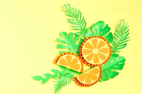 Premium Photo Paper Slices Of Orange With Paper Tropical Leaves