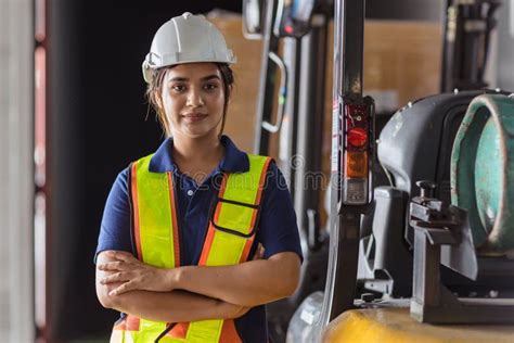 Indian Woman Staff Worker Engineer Supervisor In Safety Suit Work In Factory Warehouse Stock