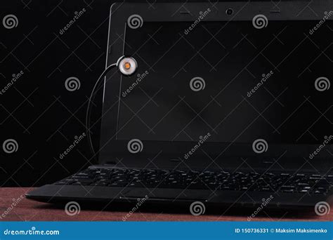 LED USB Lamp Connected To Laptop And Peeking From Behind The Monitor Concept Of Alive Usb Lamp