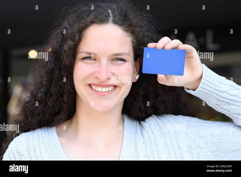 Front View Portrait Of A Woman Showing Blank Blue Credit Card In The Street Stock Photo Alamy