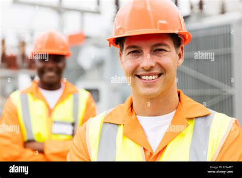 Close Up Portrait Of Young Electrical Engineer In Substation Stock