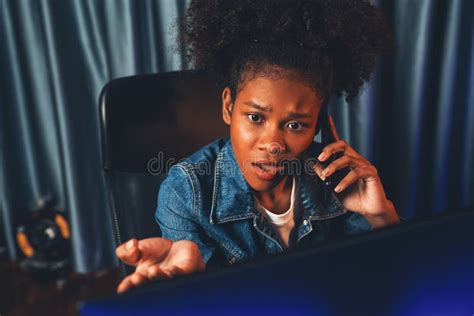 Working African Woman Concentrating Laptop And Making A Phone Call Tastemaker Stock Image