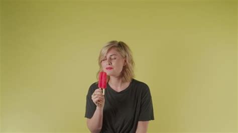 Blonde Woman Licks Popsicle Front Yellow Stock Footage Video 100