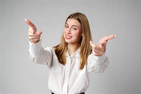 Premium Photo Young Woman In White Shirt Gesturing Come Here With