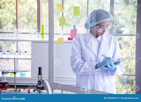 Asian Woman Scientist Hand Write Note Research In Medical Lab Look At Science Microscope Medical