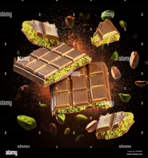 Chocolate Bars With Pistachio Cream Filling Exploding On A Black Background Creating A Dynamic