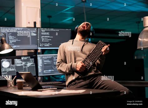 Database Programmer Playing Guitar With Keyboard Writing Code With Cloud Computing And