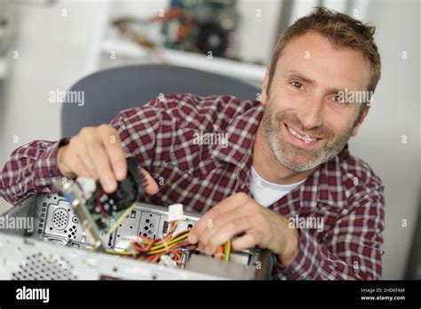 Happy Man Fixing A Pc Stock Photo Alamy