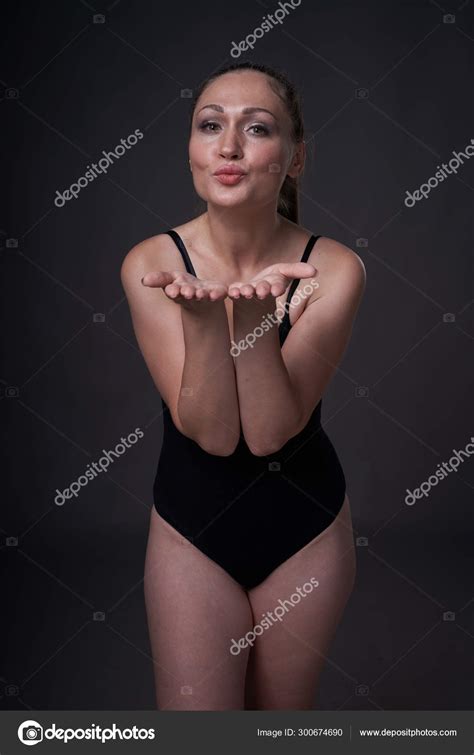 Flexible Sexy Girl Poses On A Black Grey Background In The Fitting Clothes Baud Stock Photo