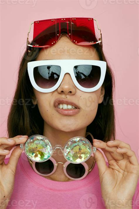 Short Haired Brunette A Lot Of Glasses On The Face In A Pink T Shirt Pink Background 25026861