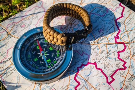 Close Up Of Metallic Magnetic Compass With Parachute Cord Bracelet On