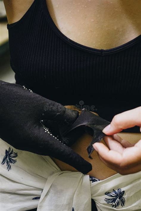 A Woman In A Glove Shows Off A Predatory Bat Indoors A Wonderful