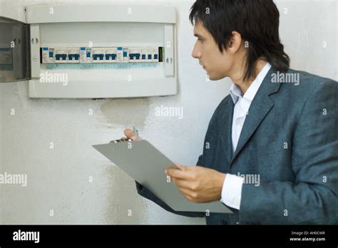 Man Inspecting Fuse Box Stock Photo Alamy