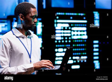 Precise Engineer Inspecting Blade Servers Performing Data Backups And