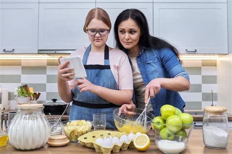 Premium Photo Mom And Teenage Daughter Preparing Apple Pie Together
