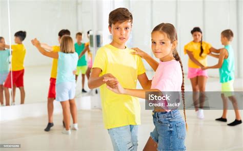 Tween Boy And Girl Practicing Slow Pair Dancing During Group Class