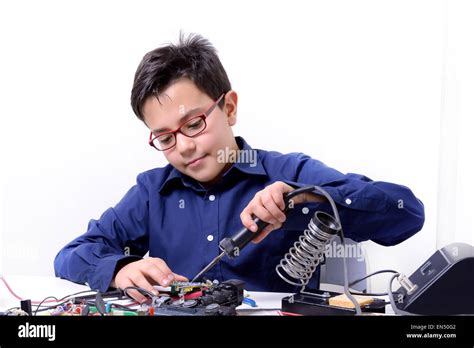 Young Student Performs Experiments In Electronics And Dreams Of The