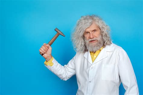 노인 착용 의사의 가운 스튜디오 고립 에 푸른 서 와 망치 찾고 카메라 심각한 곱슬 머리에 대한 스톡 사진 및 기타 이미지 곱슬 머리 괴짜 기이함 Istock