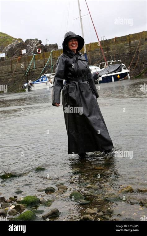 Mature White Caucasian Woman In Designer Rainwear Enjoying The Rain