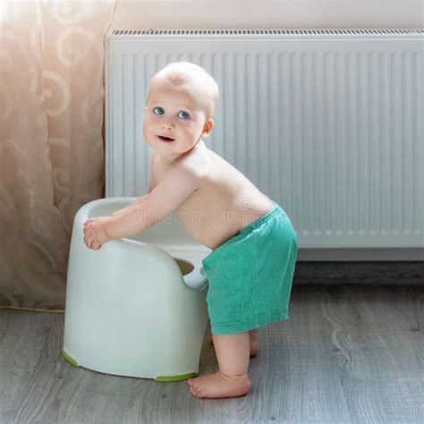 Cute Little Blond Caucasian Boy In Funny Green Shorts Playing With