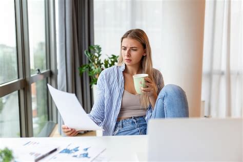 premium photo serious frowning woman sit at workplace desk looks at