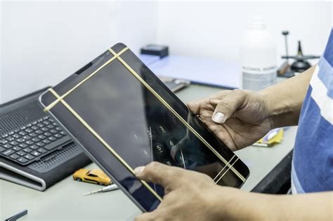 Premium Photo An Electronics Technician Disassembling A Smart Mobile