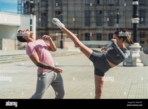 Flexible Female Kickboxer Kick Her Male Friend In A Head With Her Leg