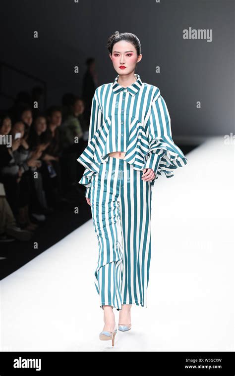 A Model Displays A New Creation At The Fashion Show Of Lli Yang By