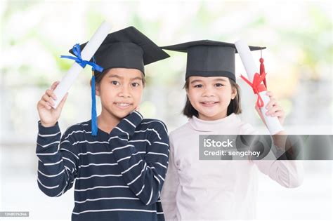 졸업 모자를 가진 두 개의 행복한 아시아 여성 학교 아이 졸업생은 압연 인증서를 보유하고 2명에 대한 스톡 사진 및 기타 이미지 2명 고등학교 이하 교육 Istock