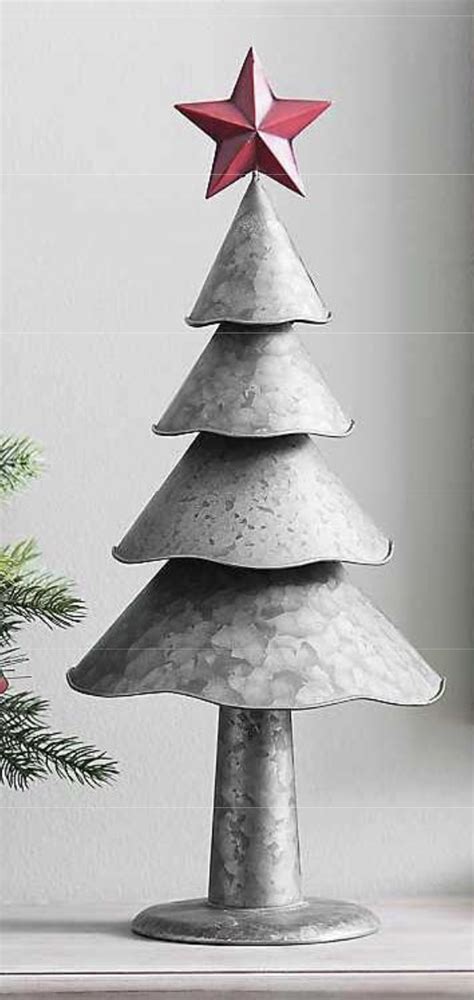 A Galvanized Metal Christmas Tree With Three Tiers Of Scalloped Metal