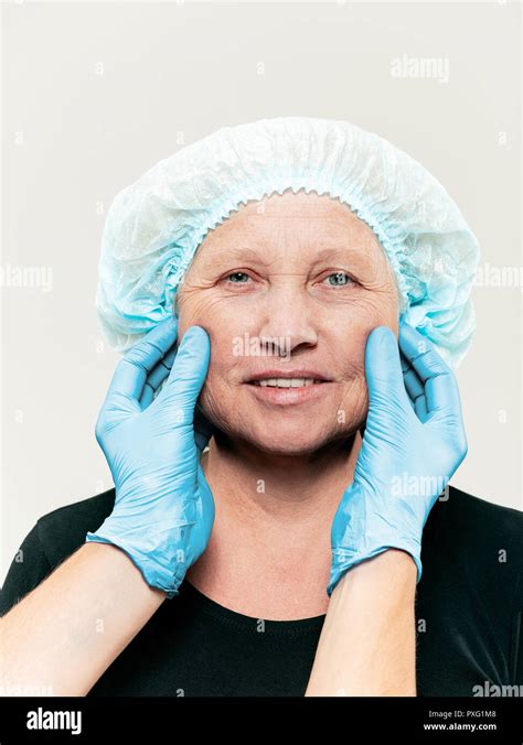 The Surgeon Doing Skin Check On Mid Age Woman Before Plastic Surgery