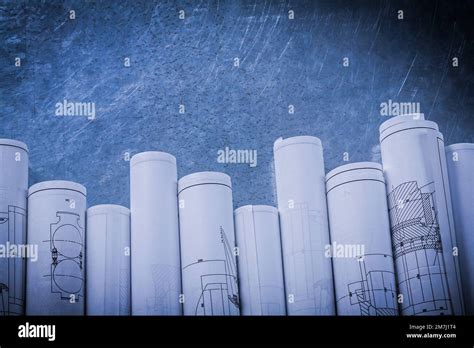 Vintage Scratched Silver Metal Background With Rolls Of Blueprints Horizontal Version Building
