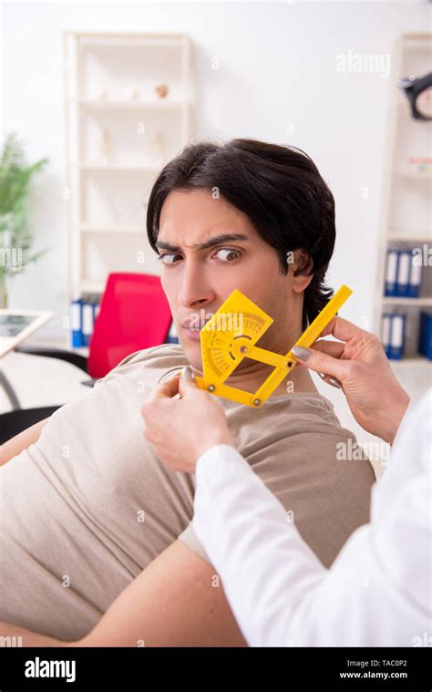 Female Doctor Checking Patients Joint Flexibility With Goniometer