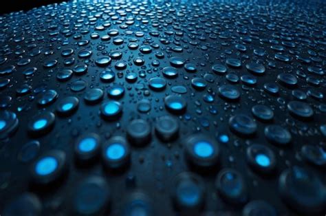 Water Droplets On A Blue Surface With The Blue Light Reflecting Off The Surface Premium Ai