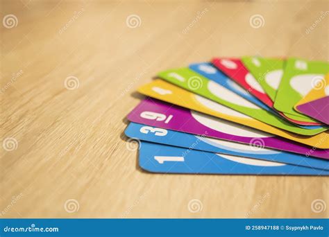 On The Wooden Table Are Playing Cards Of Different Colors The Cards On