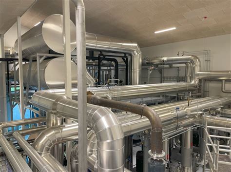 Large Scale Transmission Network As Key To Utilising Surplus Heat For District Heating