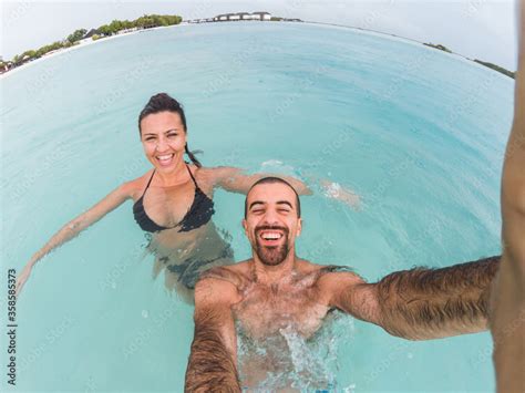 Happy Couple Taking A Candid Selfie At Maldives Resort And Enjoying
