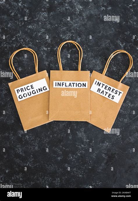Inflation Interest Rates And Price Gouging Texts On Paper Shopping Bags On Dark Background