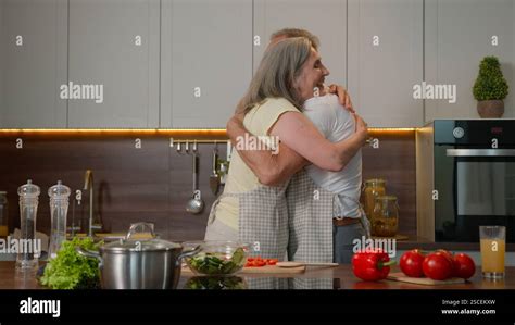 Retired Old Caucasian Love Couple Family Husband Man And Wife Woman Cooking And Dancing In