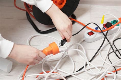 Woman Putting Plug Into Extension Cord Reel Indoors Closeup Stock Image Image Of Energy