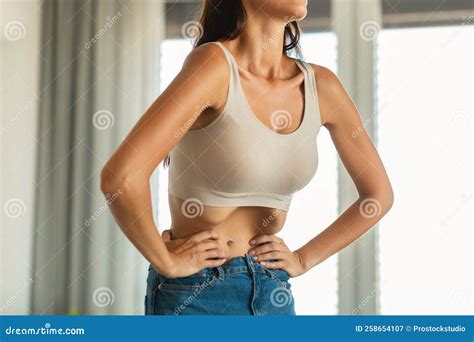 Unrecognizable Lady Doing Stomach Vacuum Exercise Standing At Home